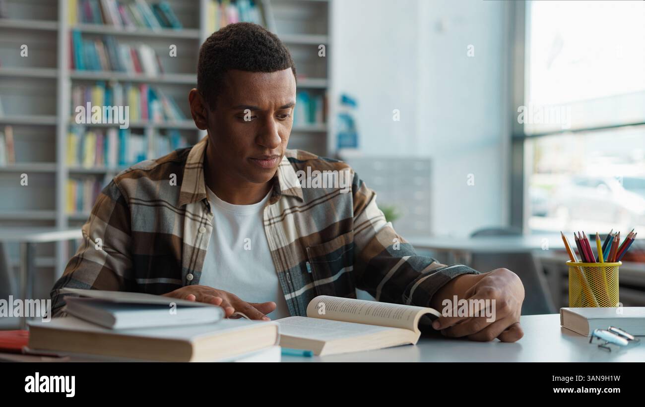 African American man male guy reading book textbook reader library ...