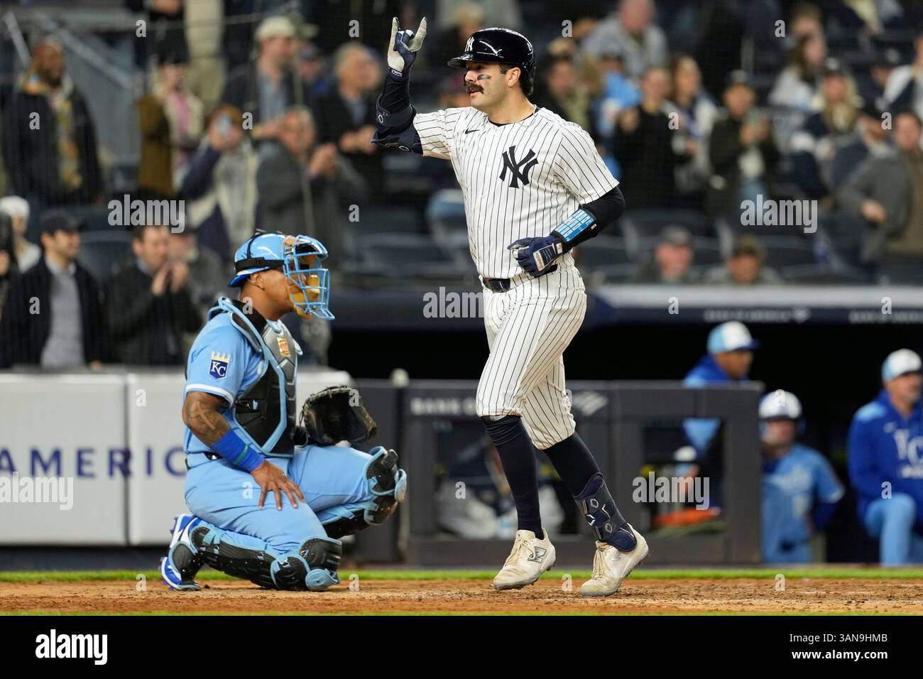 Kansas City Royals catcher Salvador Perez, left, looks on as New York ...