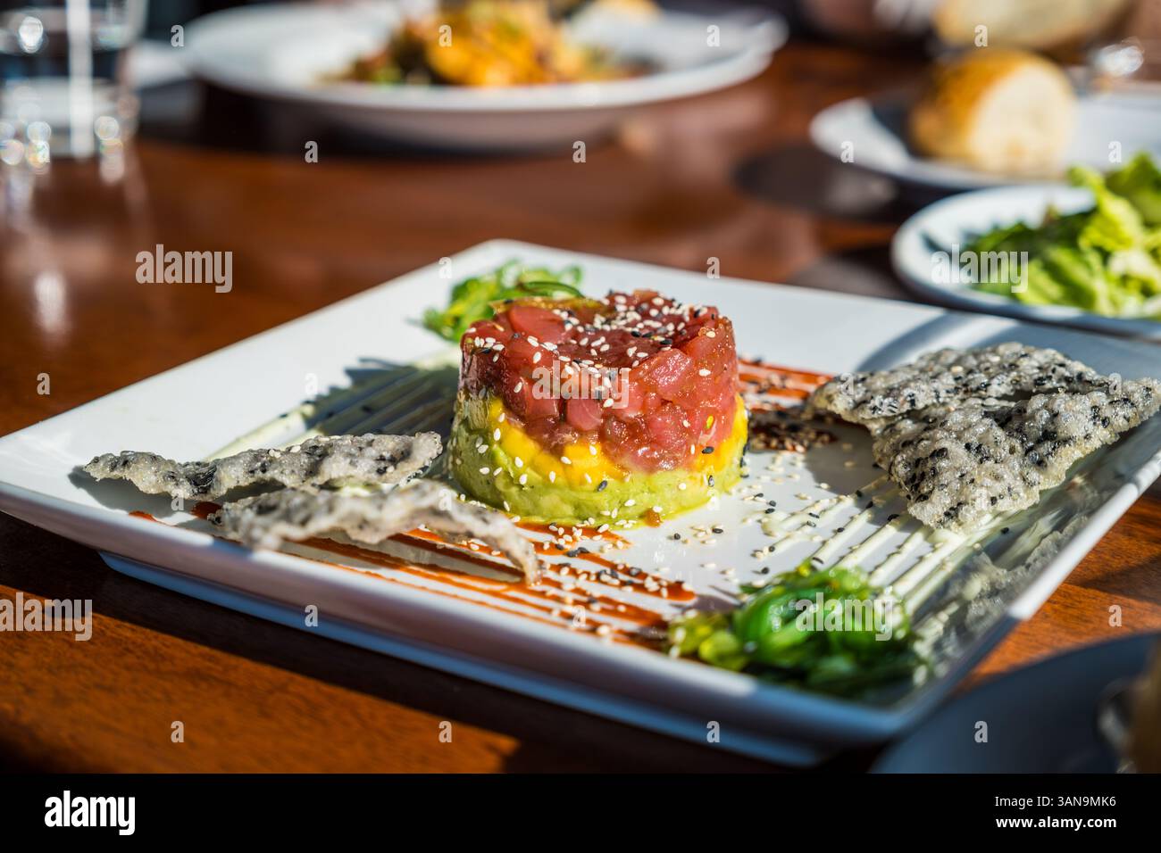 Diners savor a vibrant, gourmet plate decorated with colorful ...