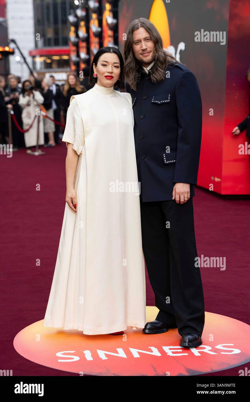 Serena McKinney, left, and Ludwig Goransson pose for photographers upon ...