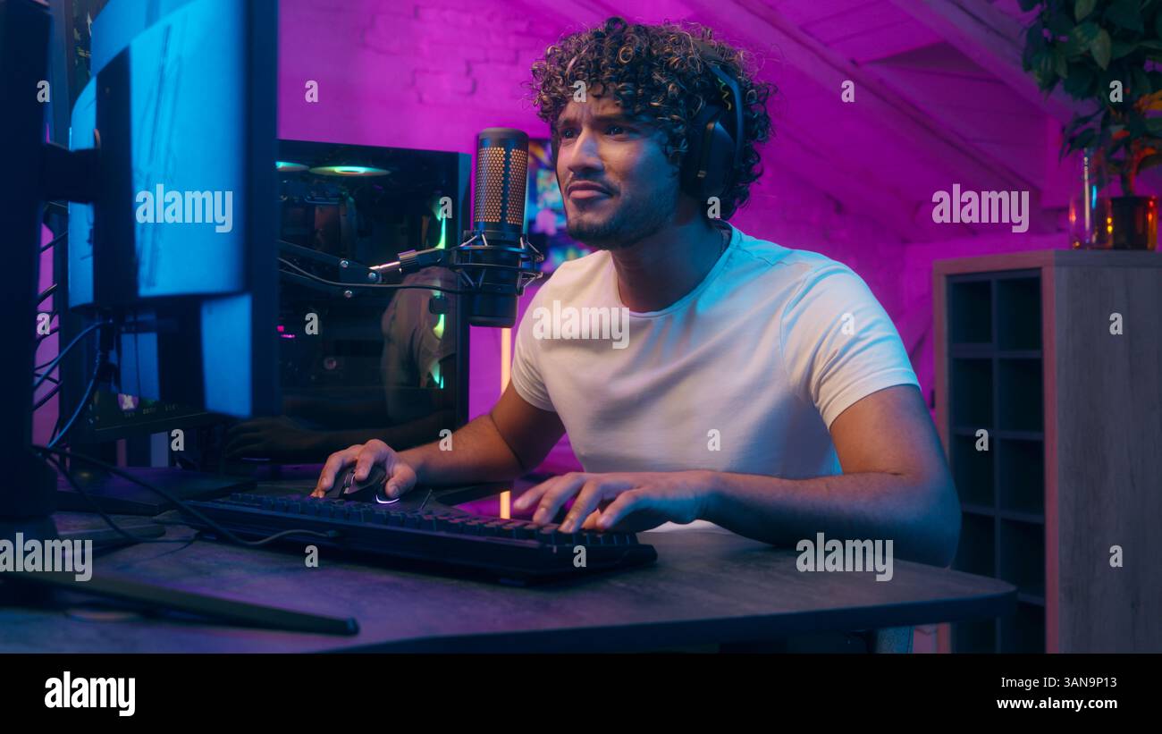 Arabian Indian American man playing game online cyber sport influencer presenter male streaming ...