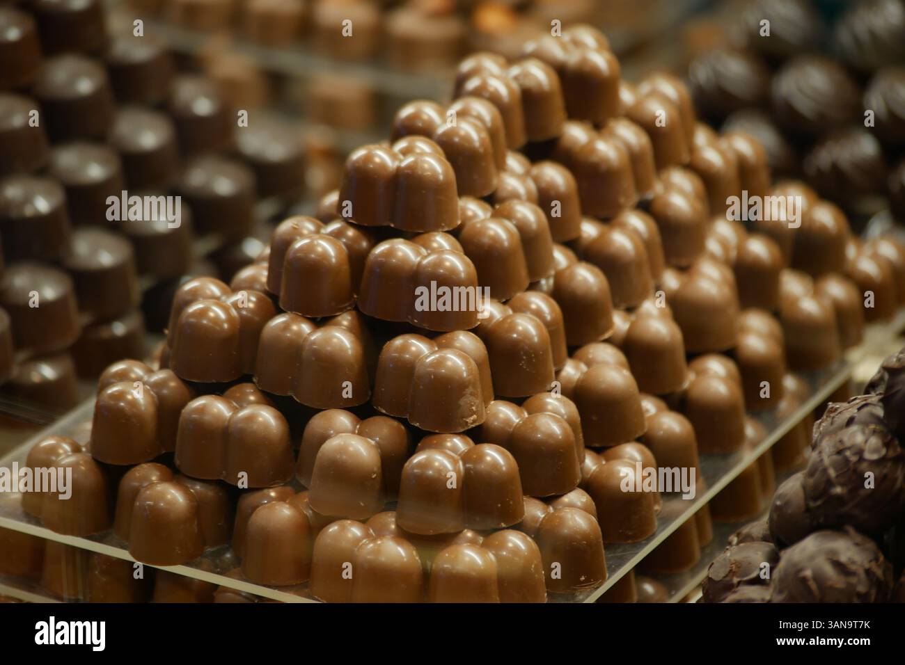 Chocolate candies arranged in decorative pyramid shape in store Stock ...