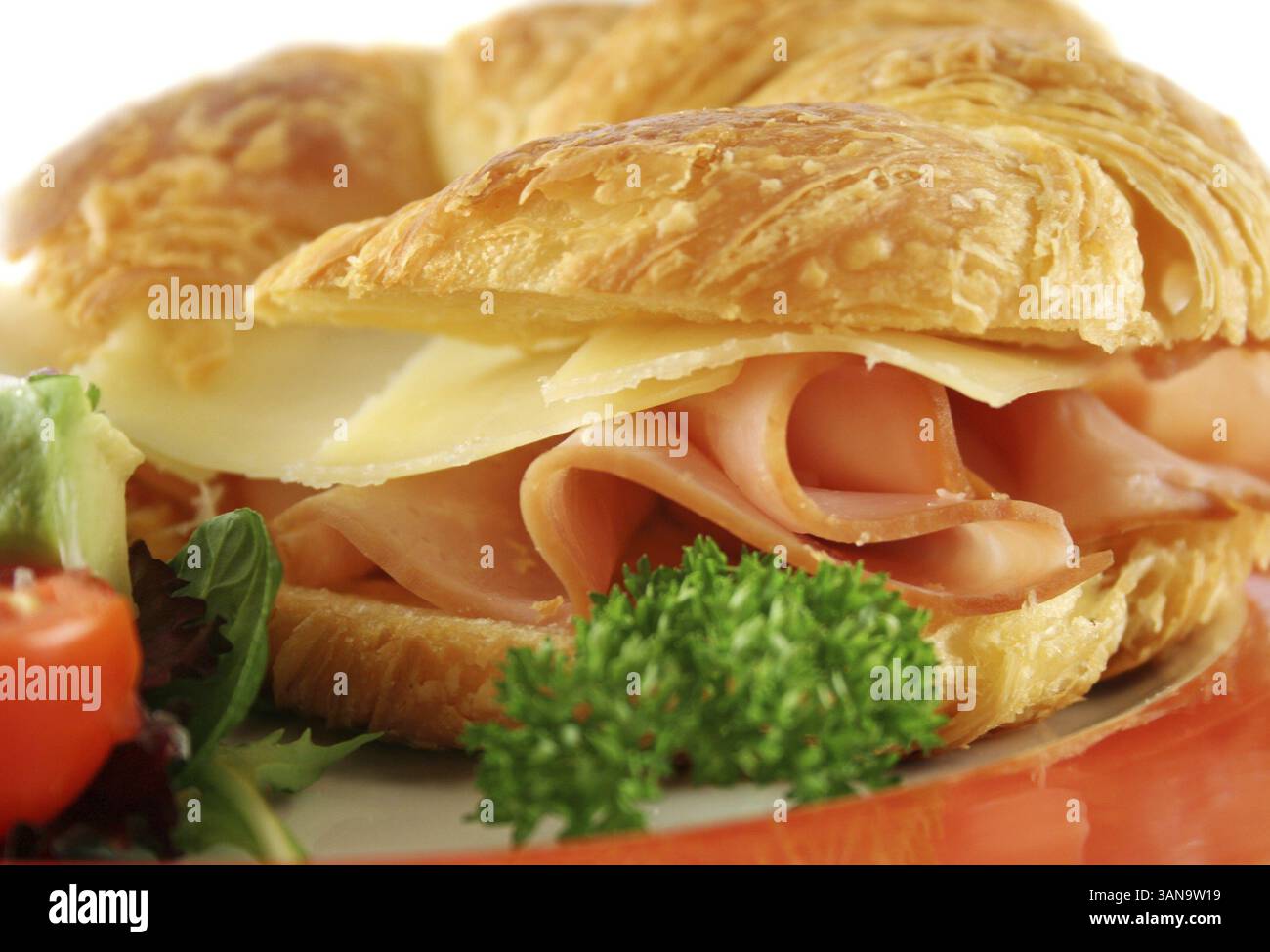 Delicious ham and cheddar cheese croissant with salad Stock Photo - Alamy