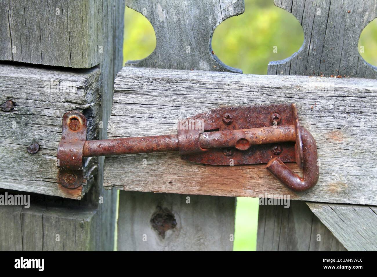 Rusty old latch on an old wooden garden gate Stock Photo - Alamy
