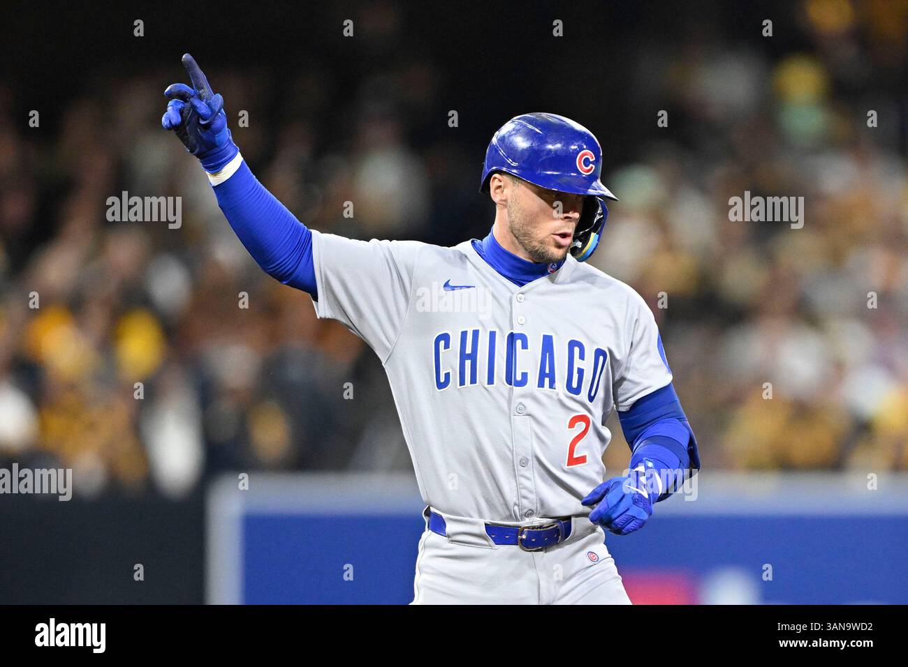 Chicago Cubs' Nico Hoerner points back to the dugout after hitting a ...