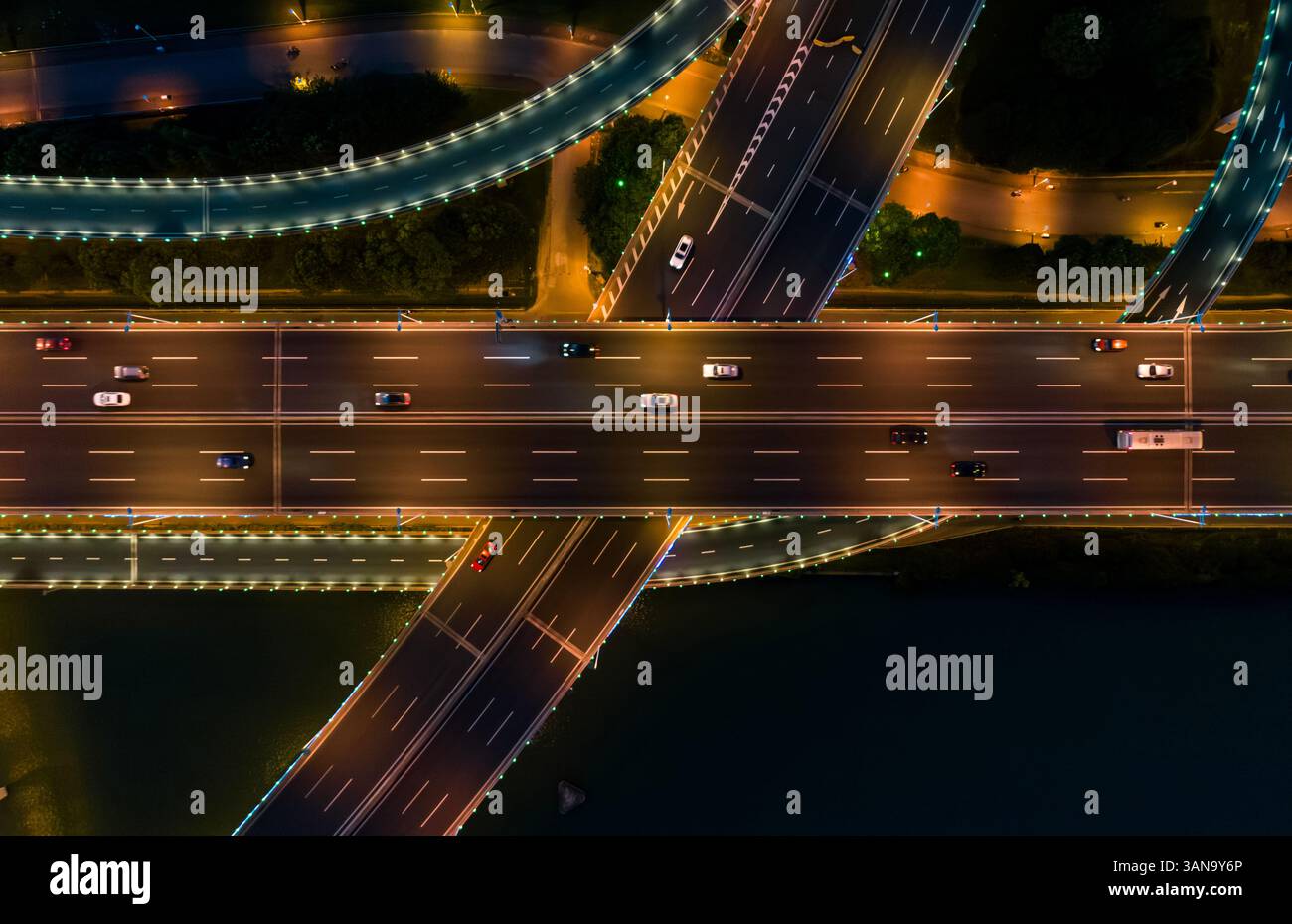 Aerial view of a busy road junction during nighttime with illuminated ...