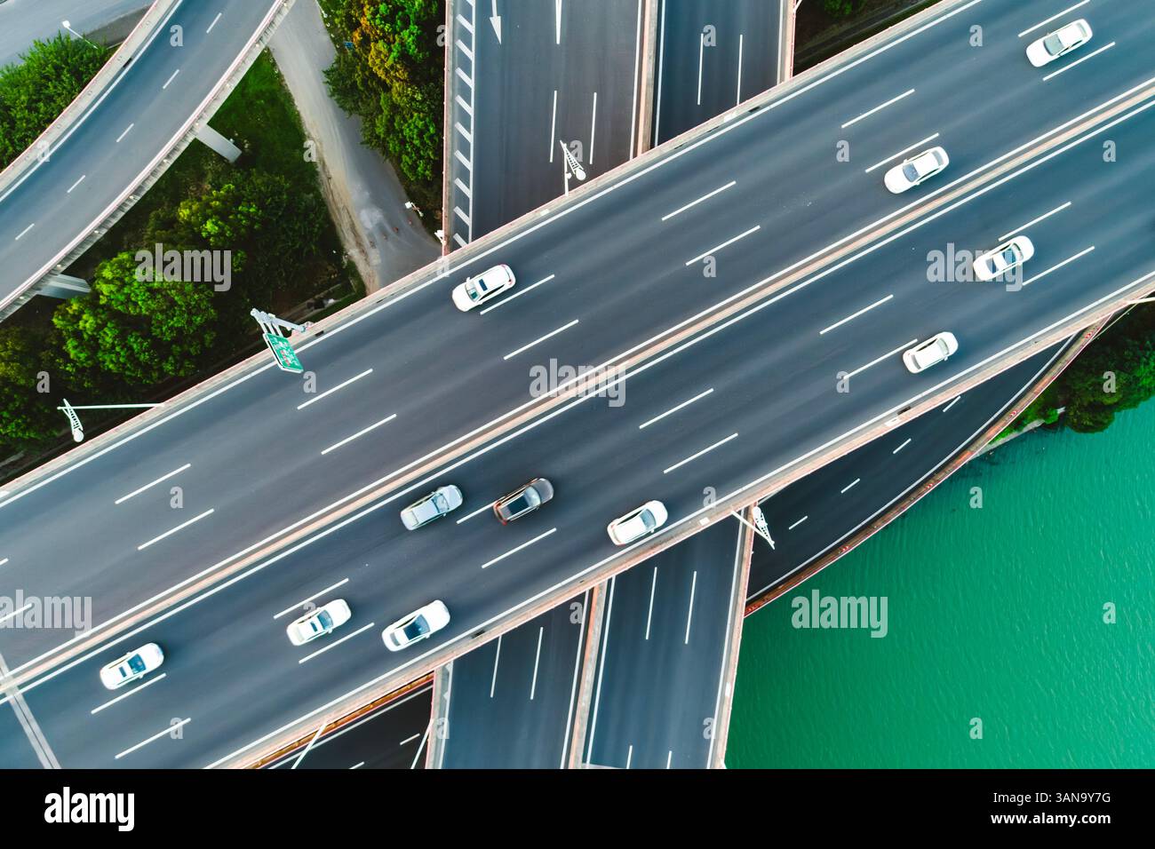 Aerial of vehicles navigate a complex highway system, showcasing ...
