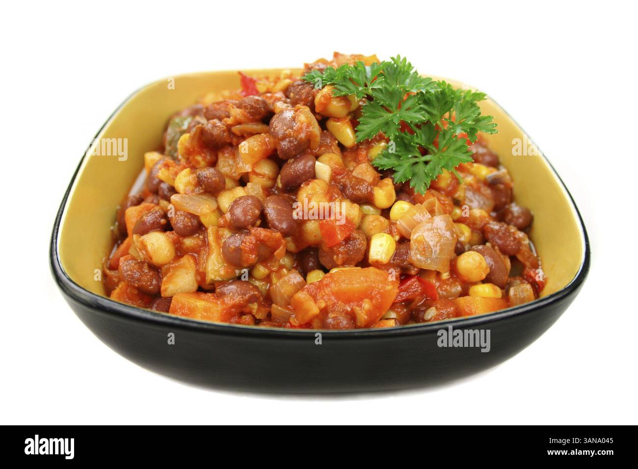 Delicious vegetable and lentil hot pot with a parsley garnish ready to ...