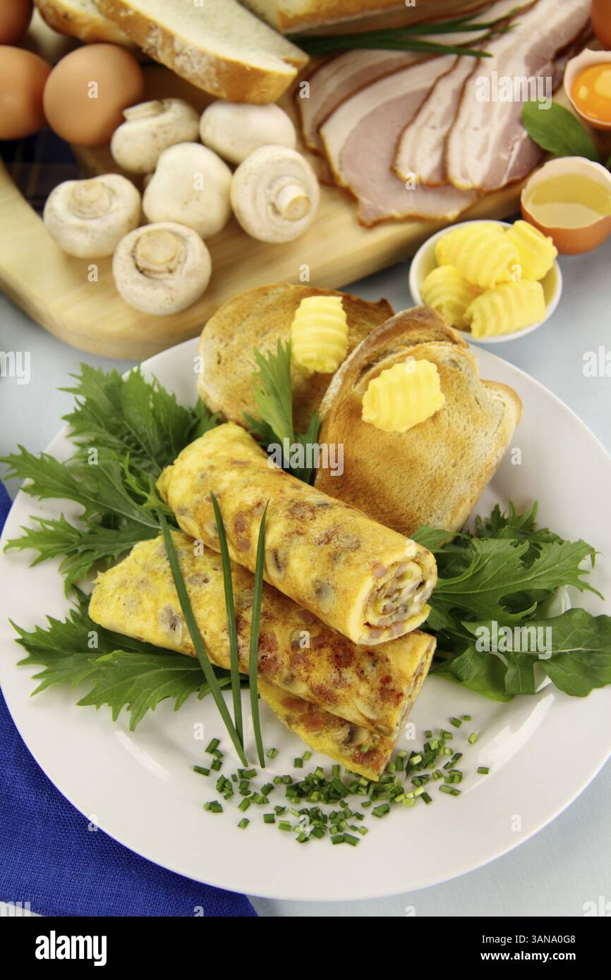 Delicious rolled mushroom and bacon omelette freshly prepared and ready ...