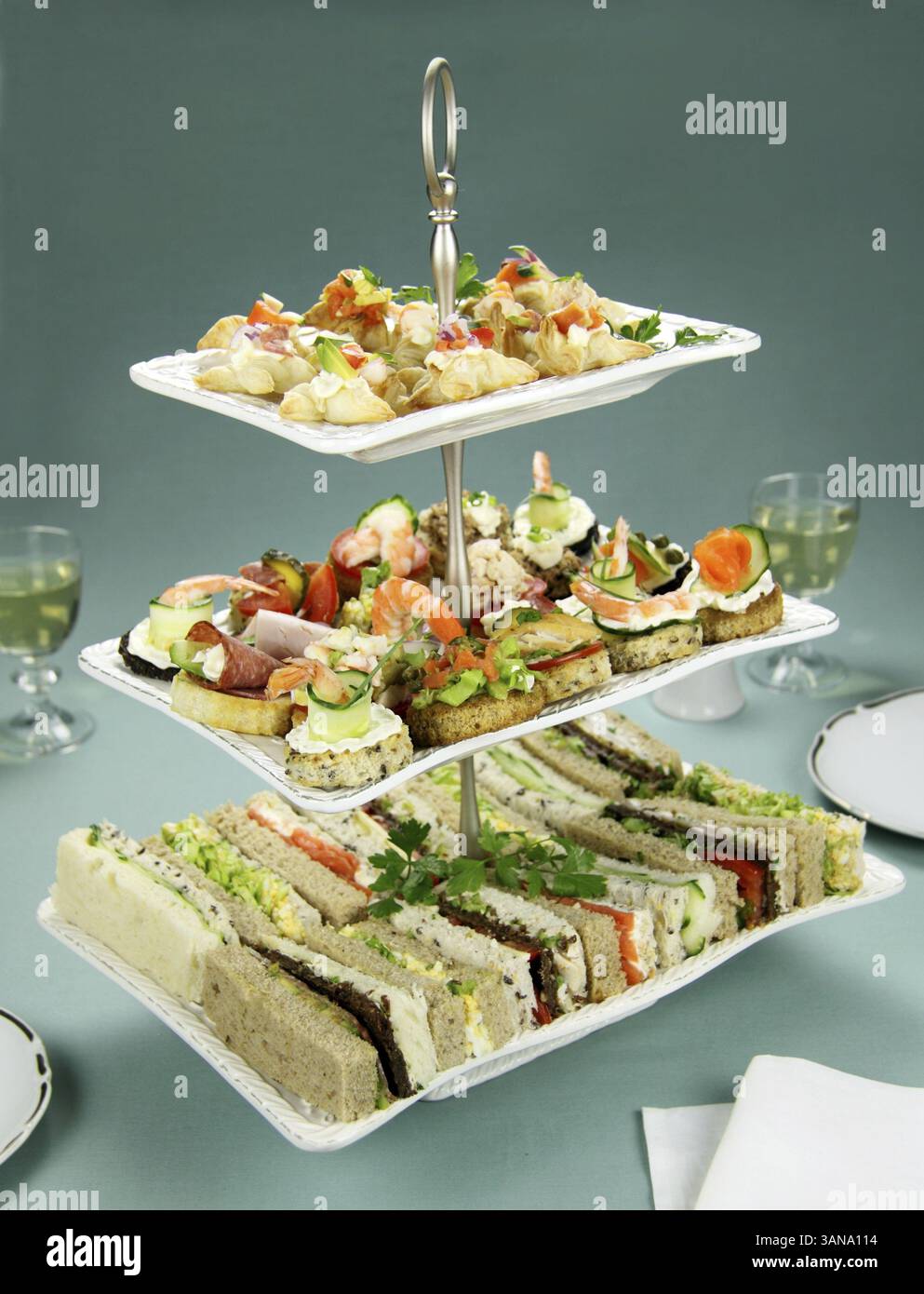 Delicious assorted finger food and sandwiches on a three tier stand ...