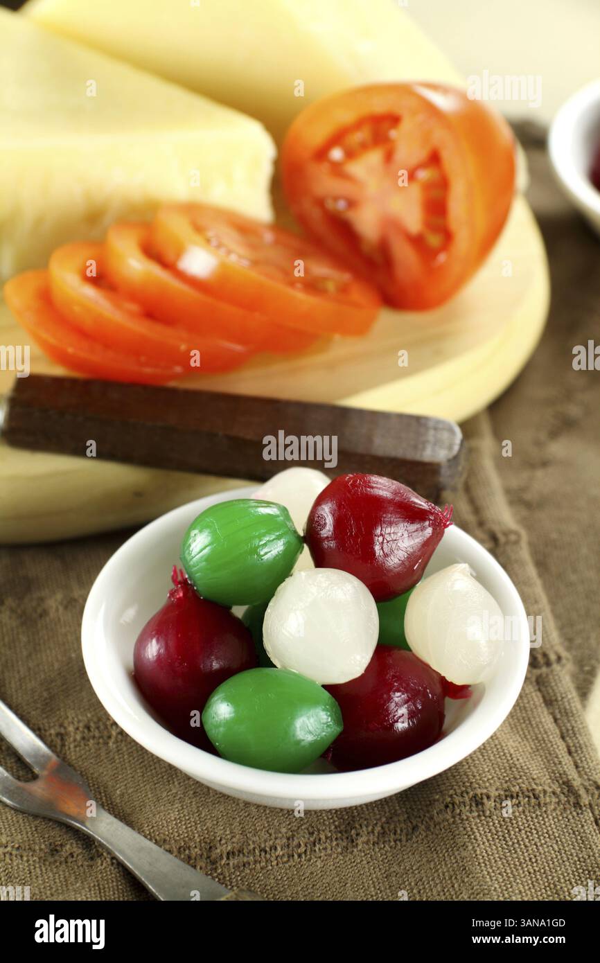 Yummy cheddar cheese with tomato and cocktail onions ready to serve ...