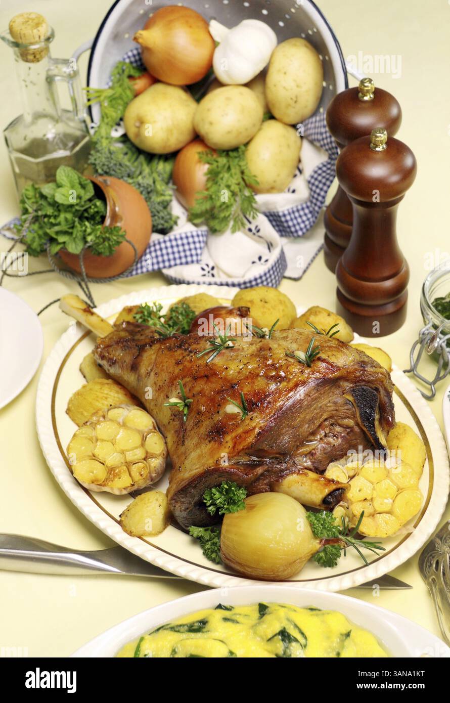 Roasted leg of lamb with vegetables, mint jelly, gravy and spinach ...