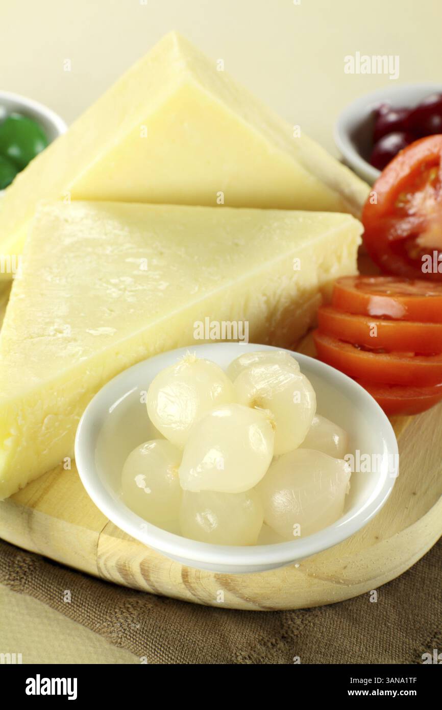 Yummy cheddar cheese with tomato and white cocktail onions ready to ...