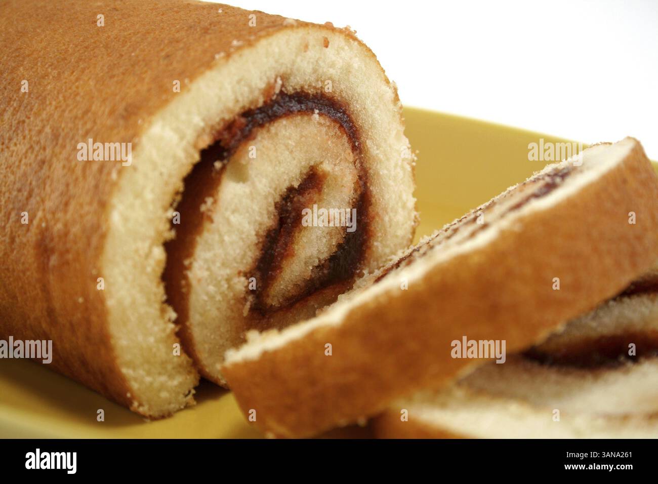 Sliced strawberry jam roll ready to serve Stock Photo - Alamy