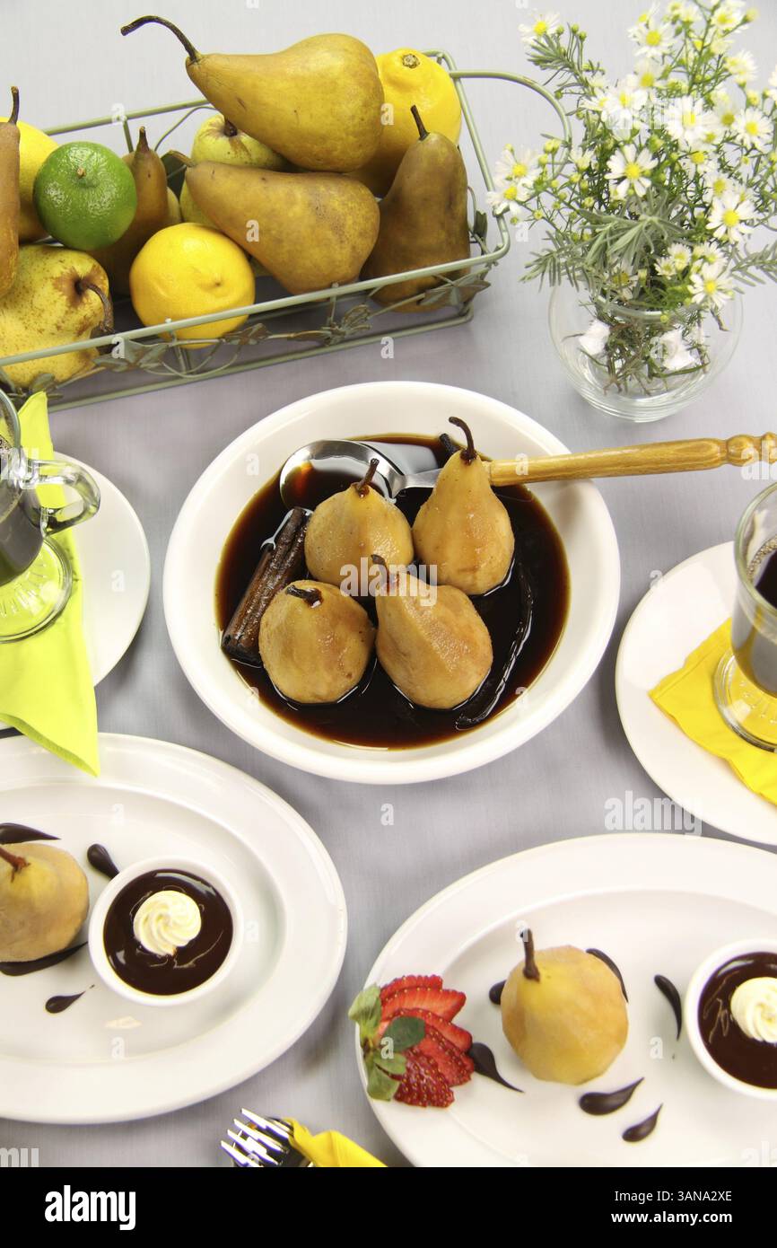 Delicious poached pears in chocolate syrup ready to serve Stock Photo ...
