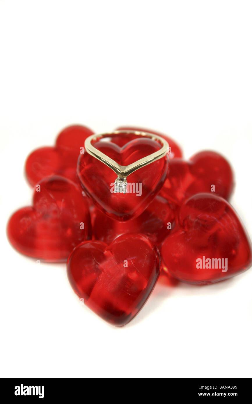 Engagement ring set on a mound of glass hearts Stock Photo - Alamy