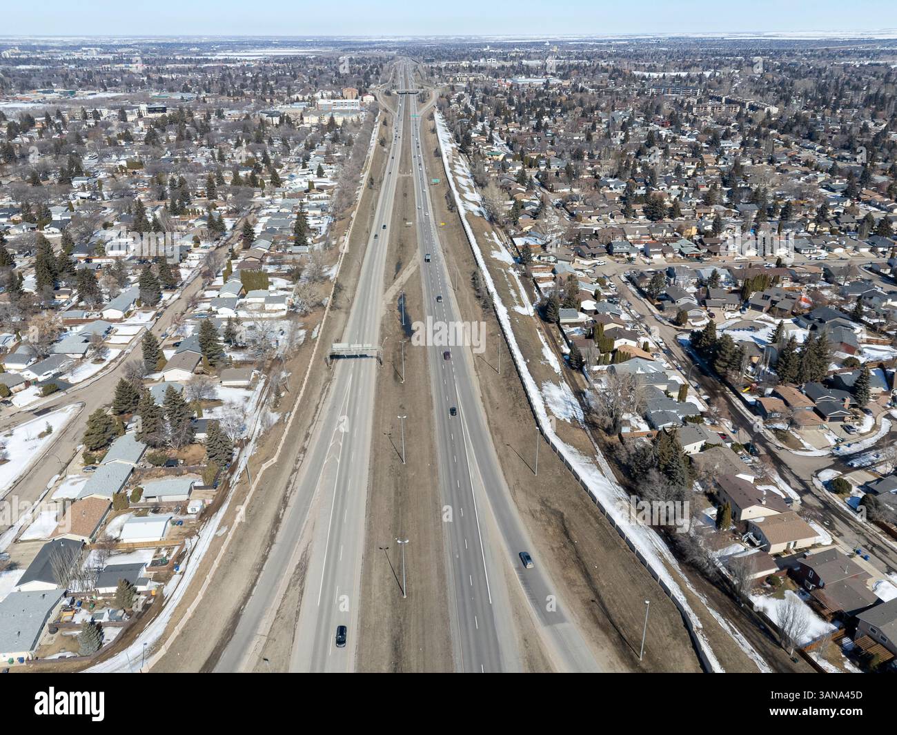 City street with a highway running through it. The street is empty and ...