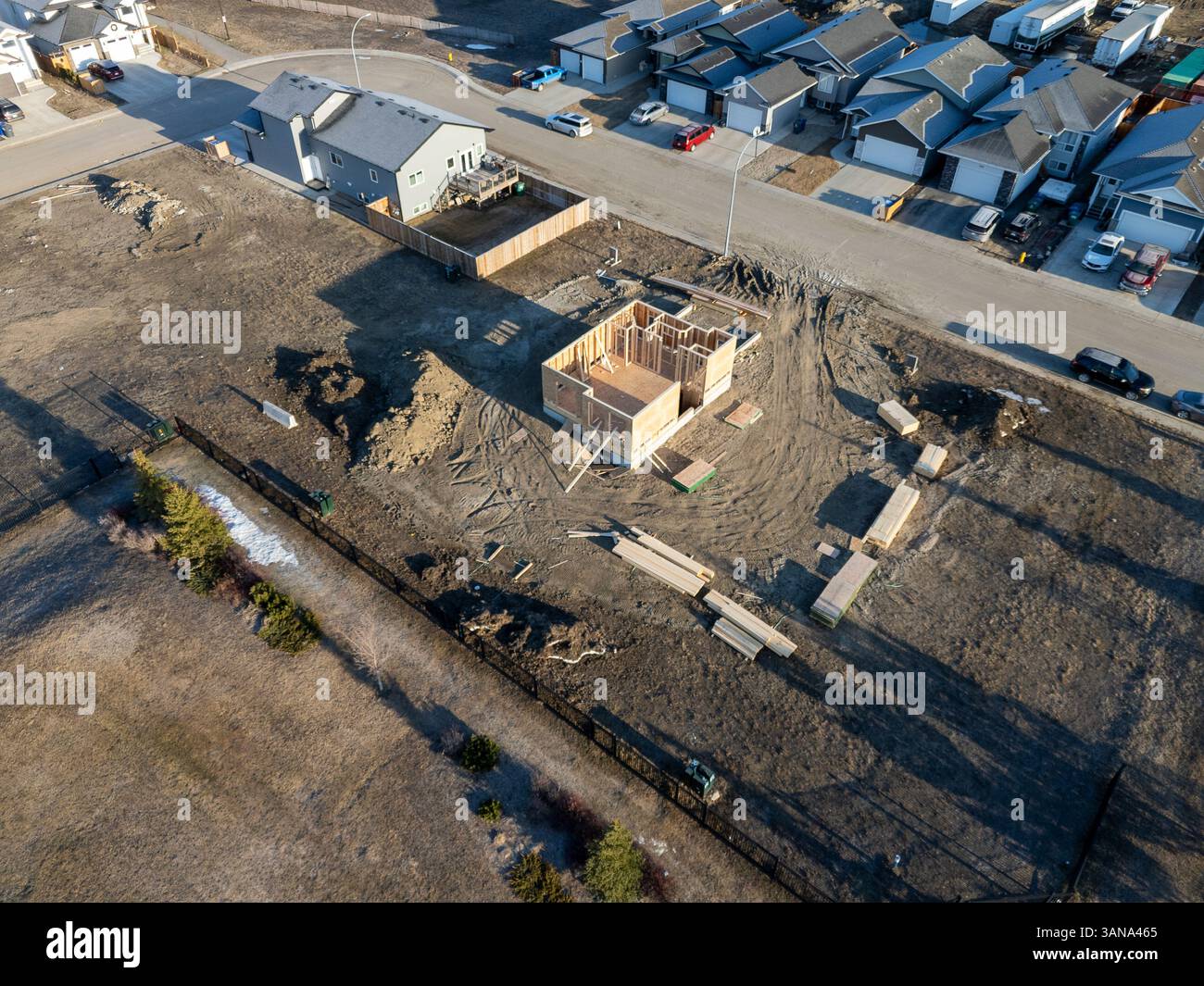 Construction site with a house in the background. The house is being ...