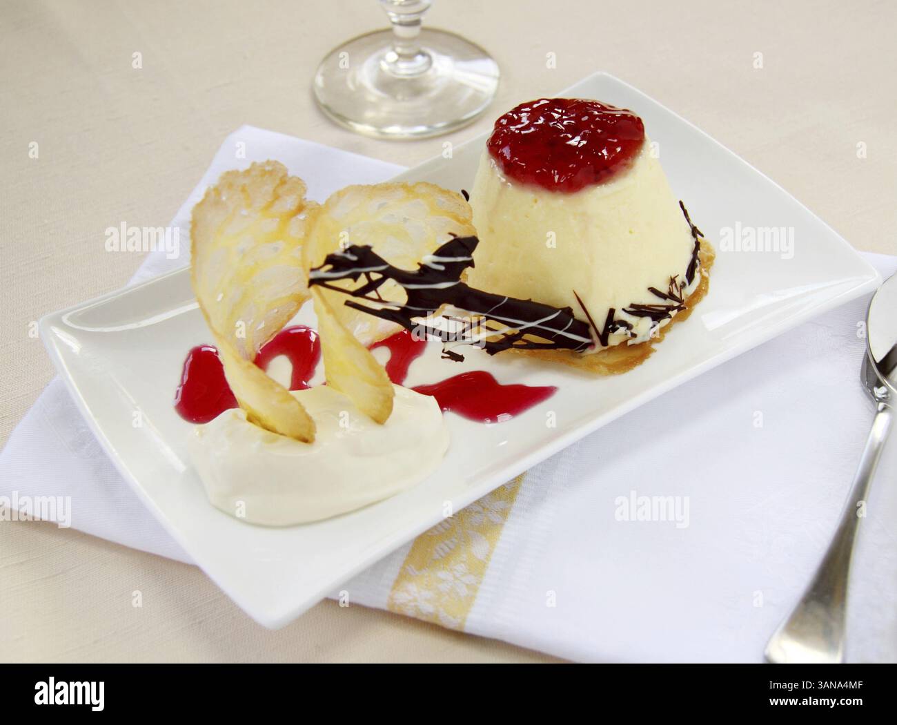 White chocolate mousse with biscuit topped with strawberry sauce Stock ...