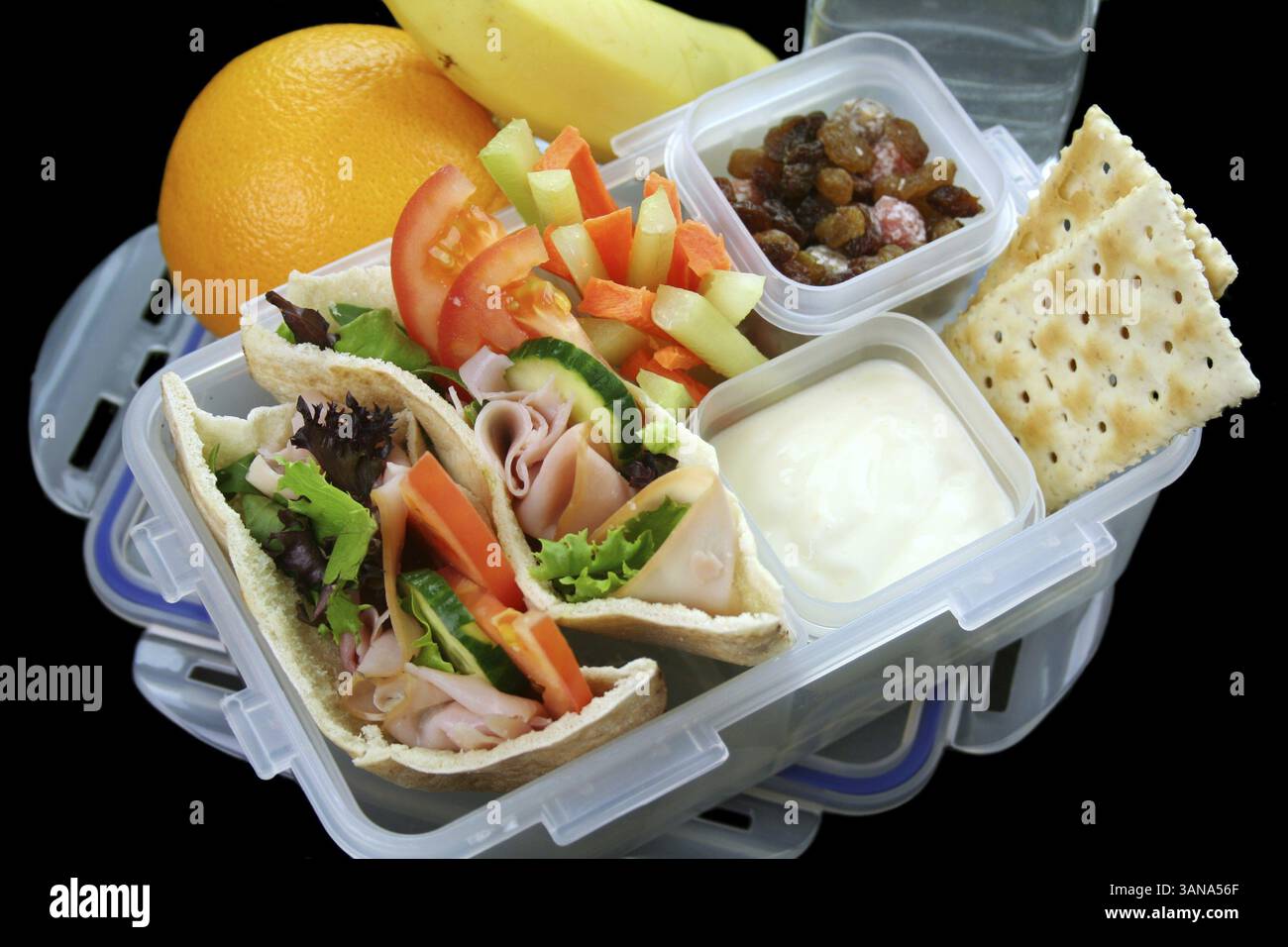 Healthy kid's lunch box made up of pita bread ham and salad, fresh ...