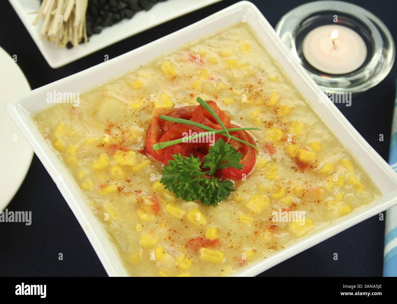 Roasted capsicum chili and corn chowder in a dark table setting Stock ...