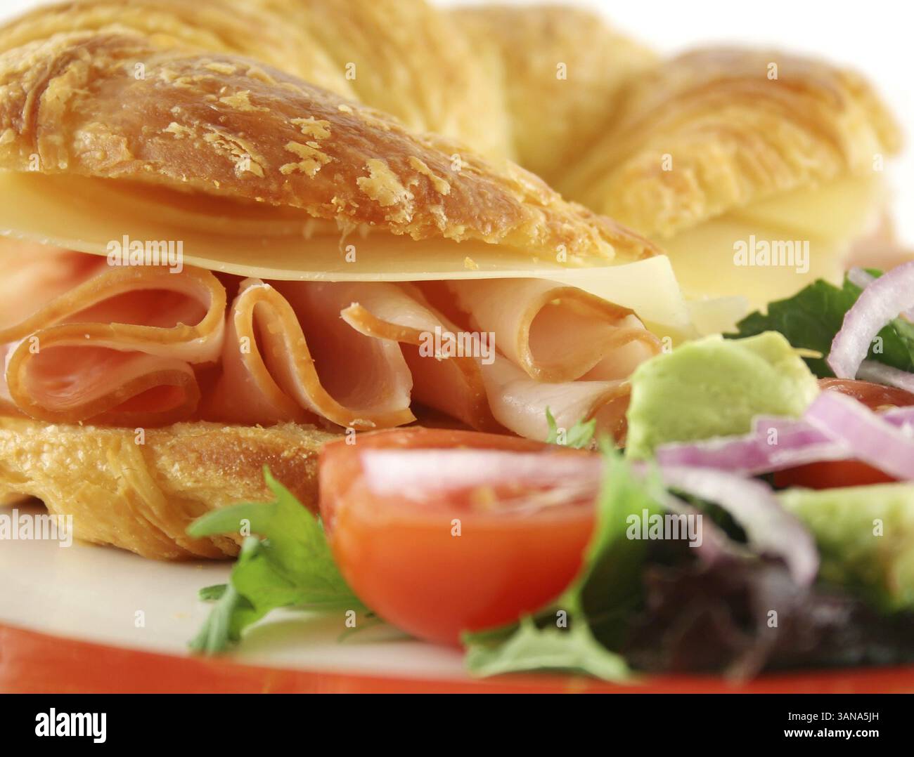 Delicious ham and cheddar cheese croissant with salad Stock Photo - Alamy