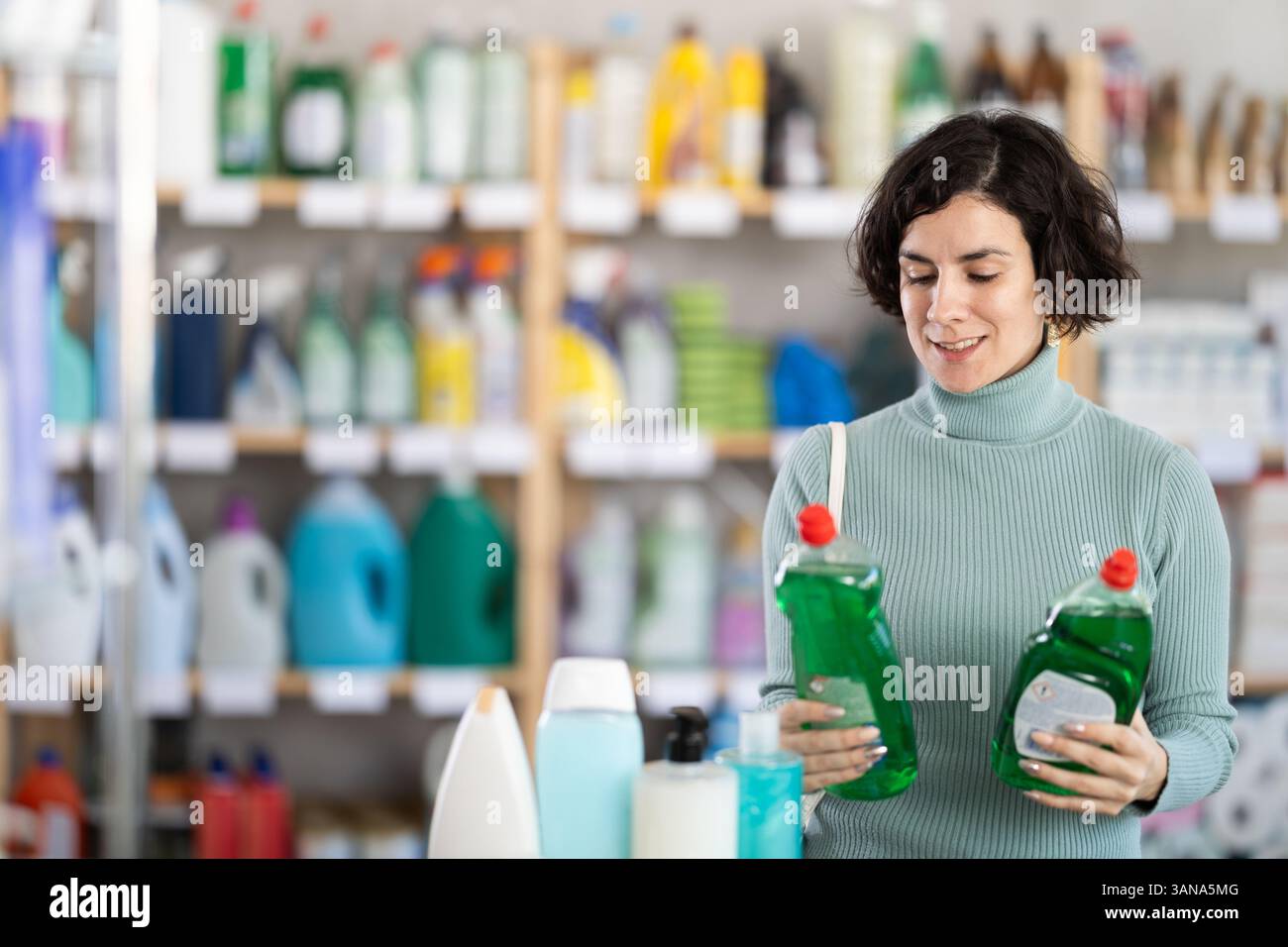 Middle-aged woman choosing dishwashing liquid at department store Stock ...