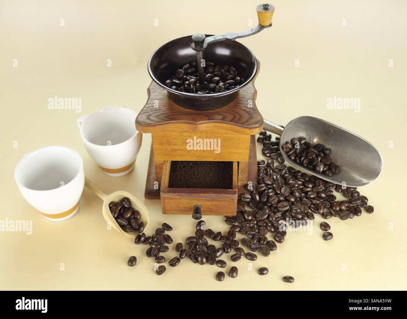 Old fashioned coffee grinder with coffee beans and ground coffee in the ...