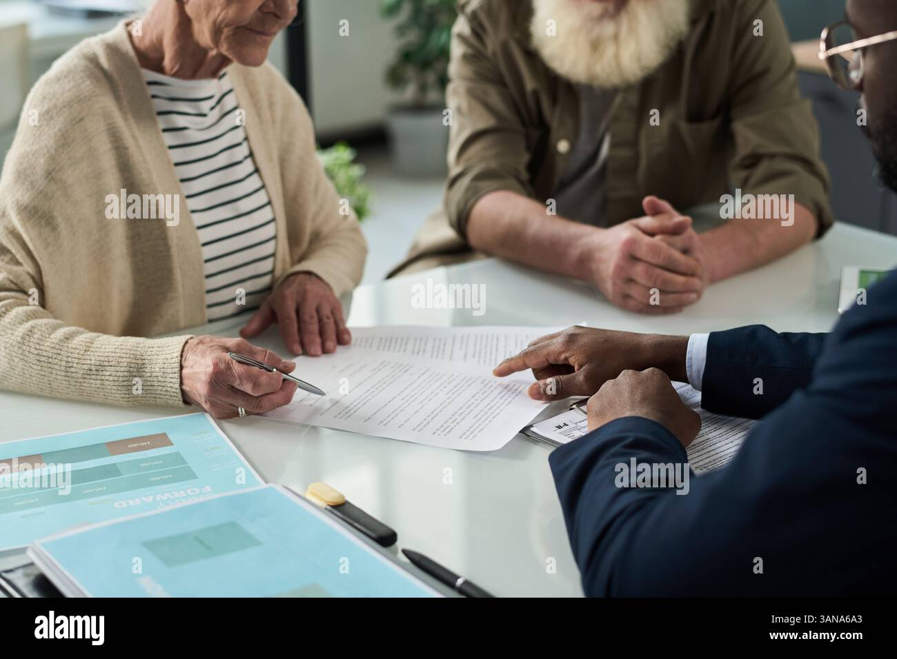 Senior couple signing finance documents hi-res stock photography and ...