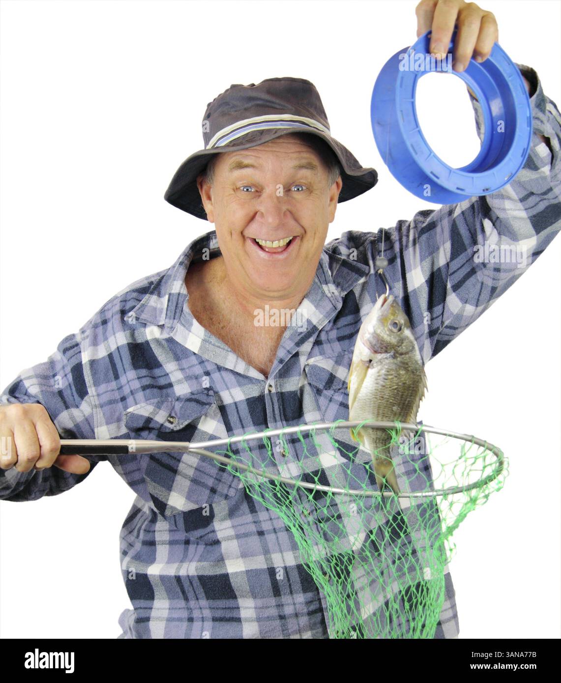 Happy middle aged fisherman holds up the fish he has just caught Stock ...