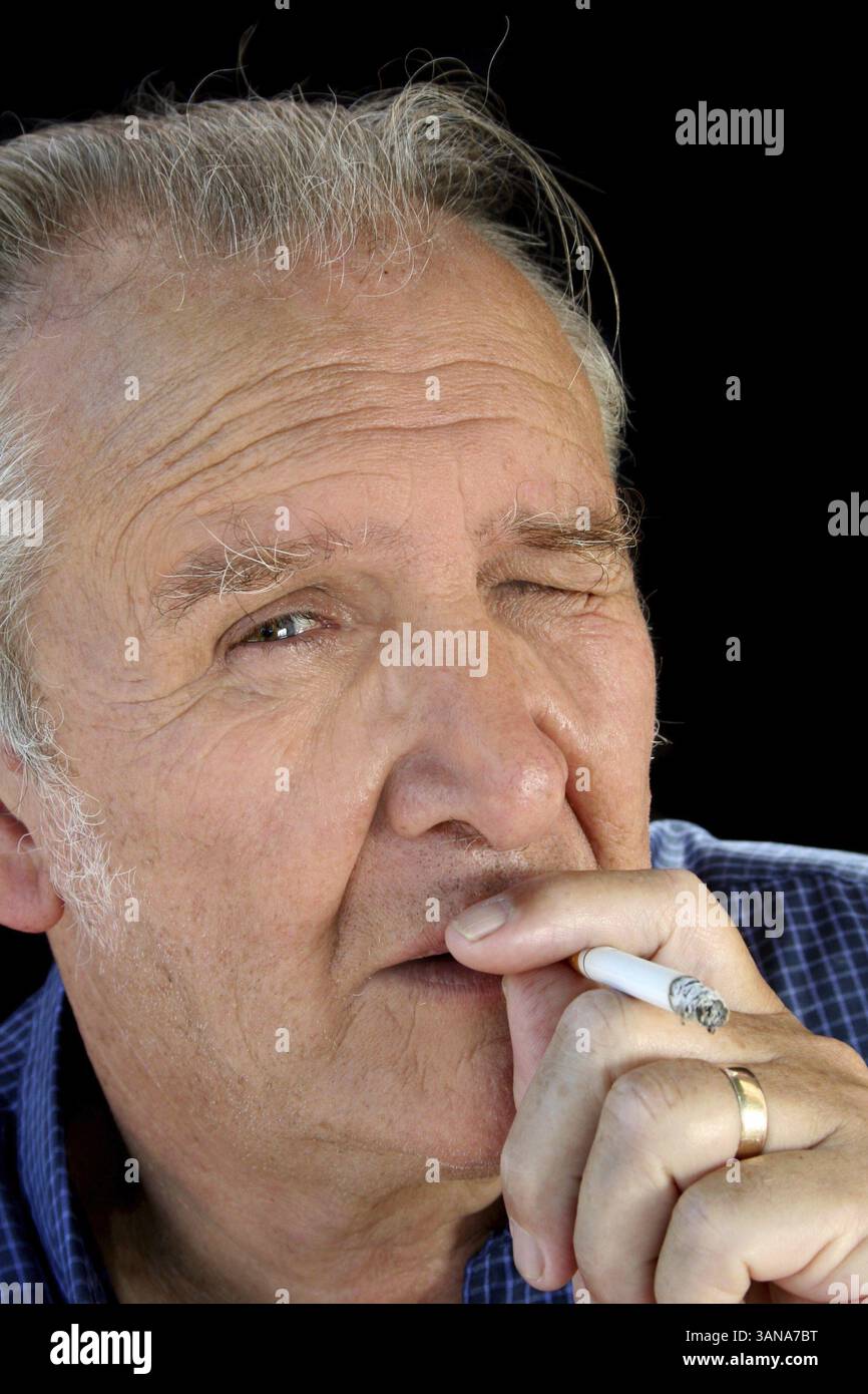 Senior male smoking a cigarette Stock Photo - Alamy