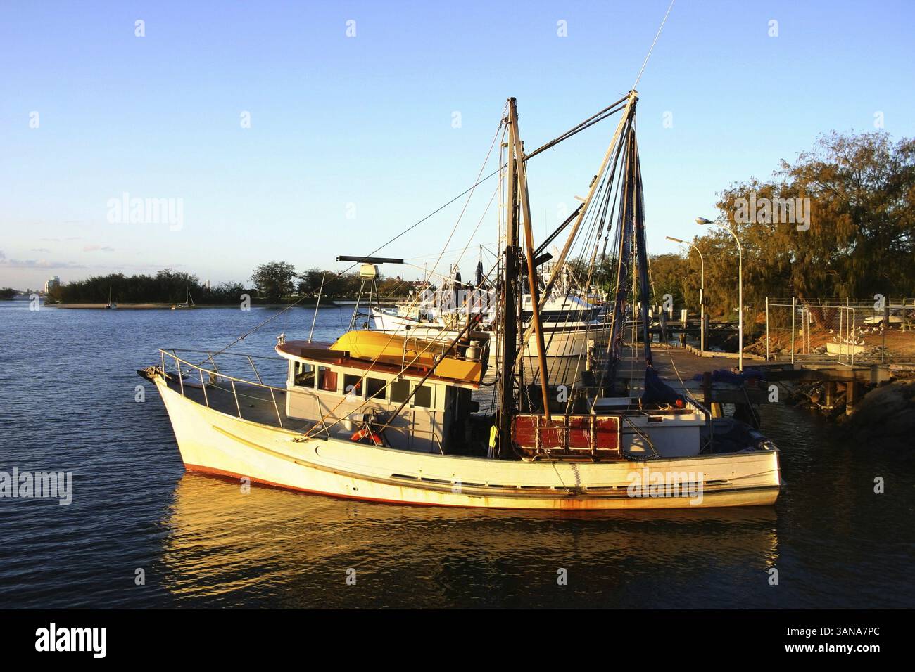 Prawn trawlers at dock at sunset tied up for the night Stock Photo - Alamy