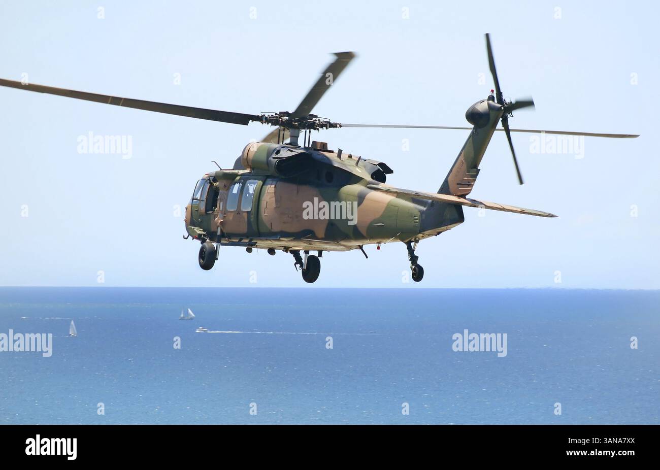 Australian Army Blackhawk chopper flies over the Pacific Ocean Stock ...
