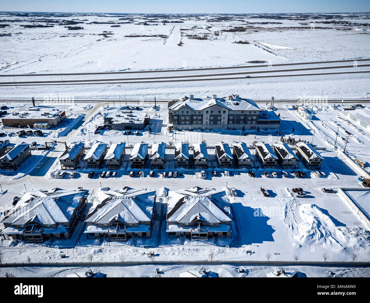 Snowy landscape with a large building in the middle. The building is ...