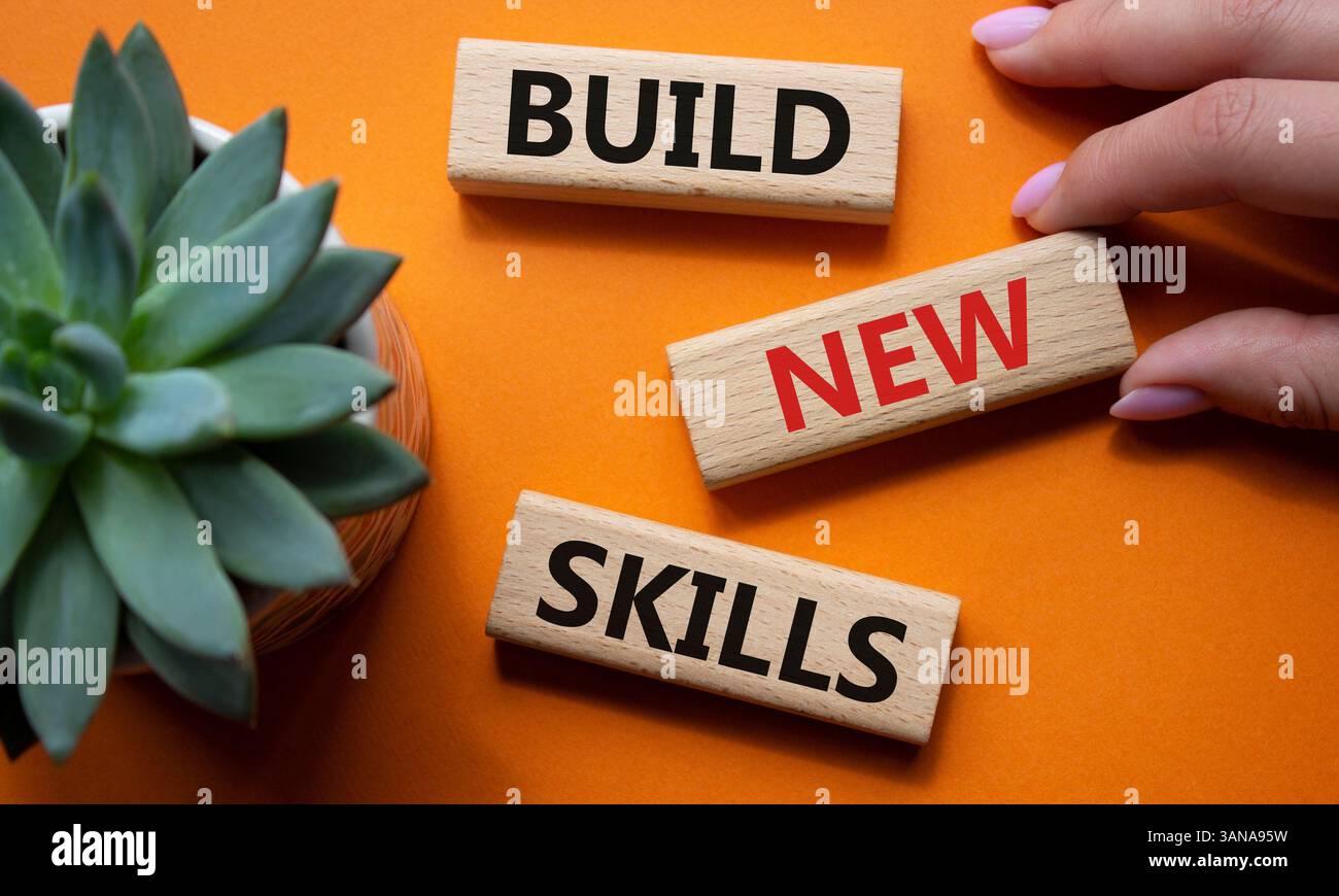 Build New skills symbol. Concept word Build New skills on wooden blocks ...
