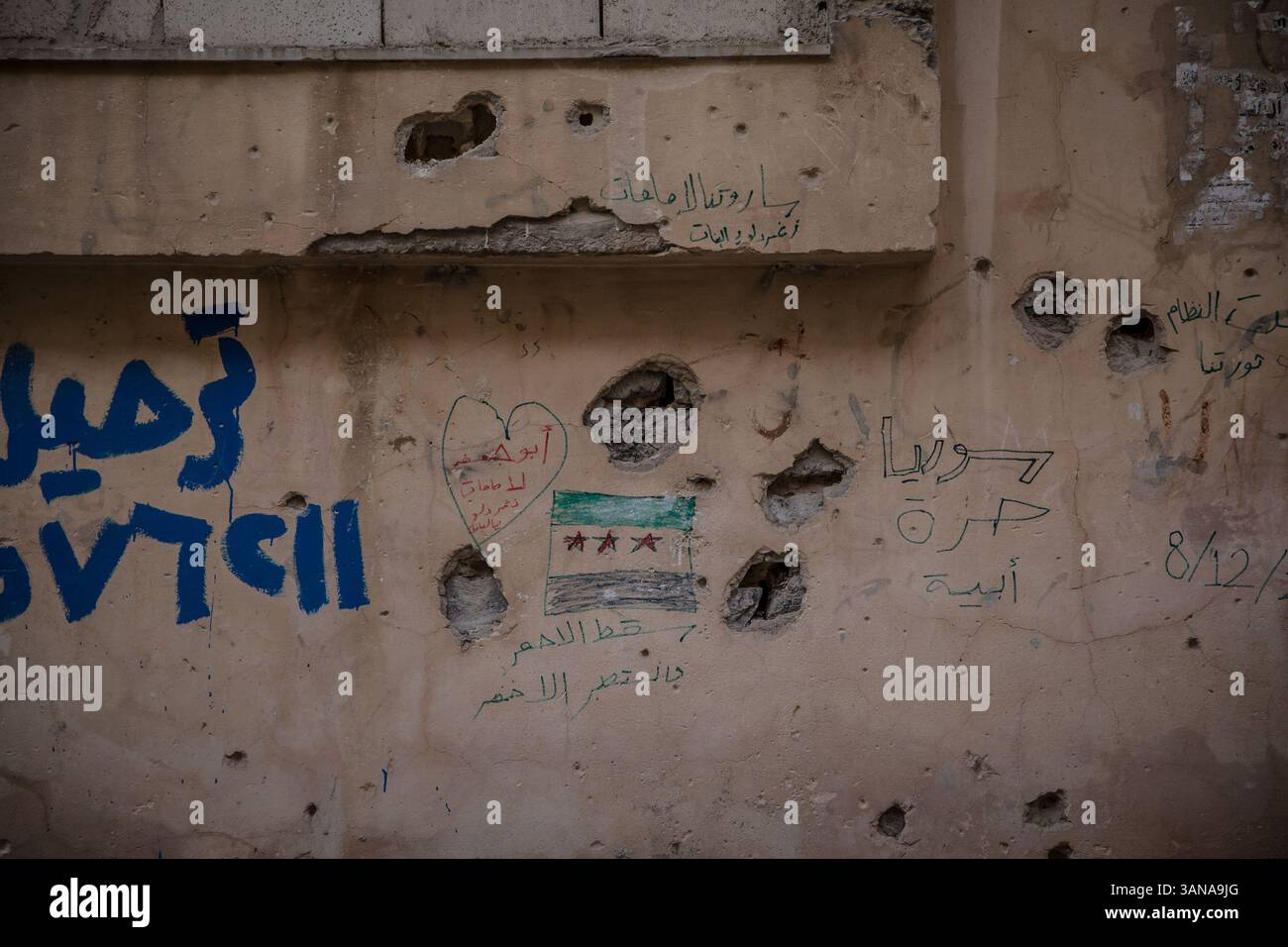 Homs, Syria. 25th Mar, 2025. Graffiti of the Syrian revolutionary flag ...