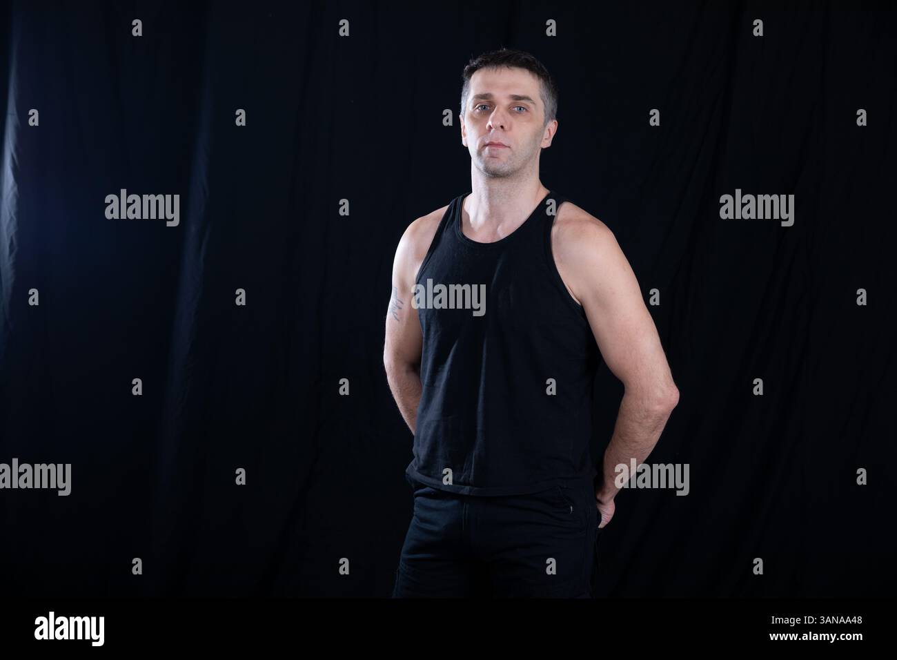 40 years old man in black clothes on background Stock Photo - Alamy