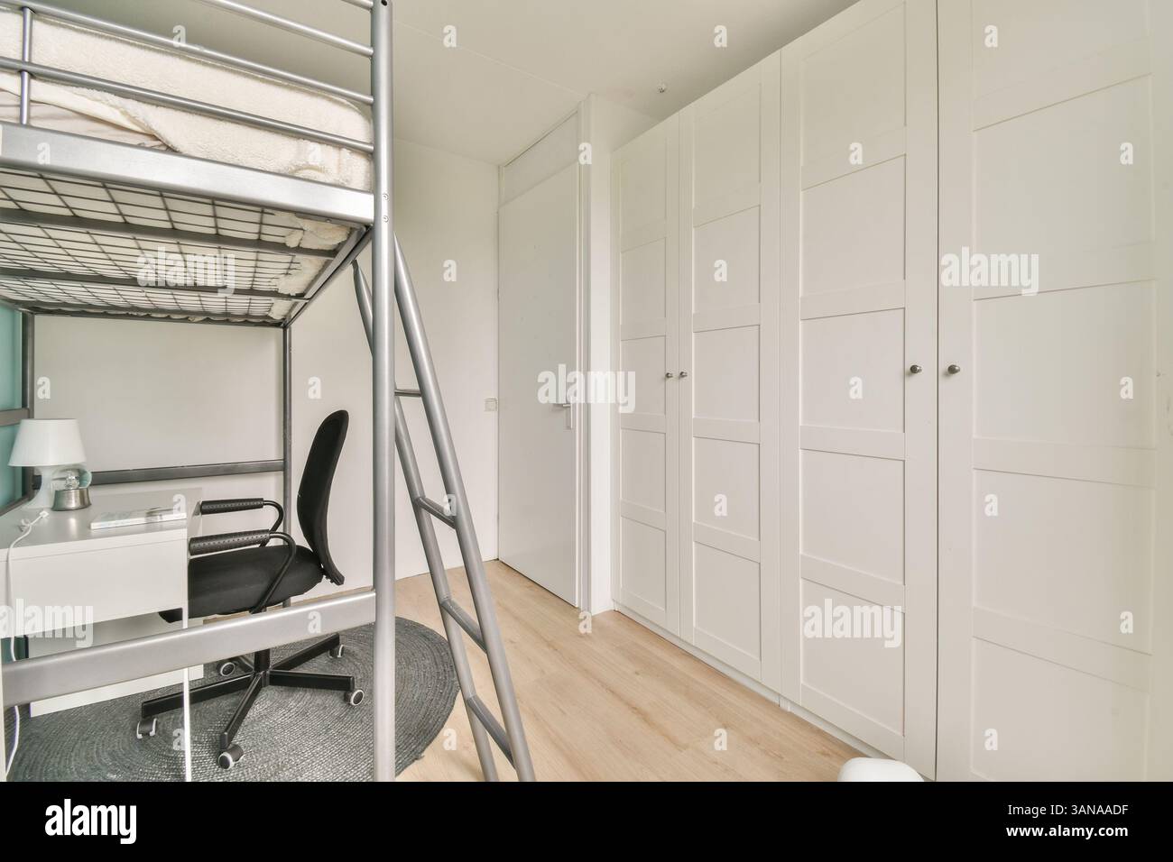 A sleek, contemporary bedroom featuring a bunk bed, study area, and ...