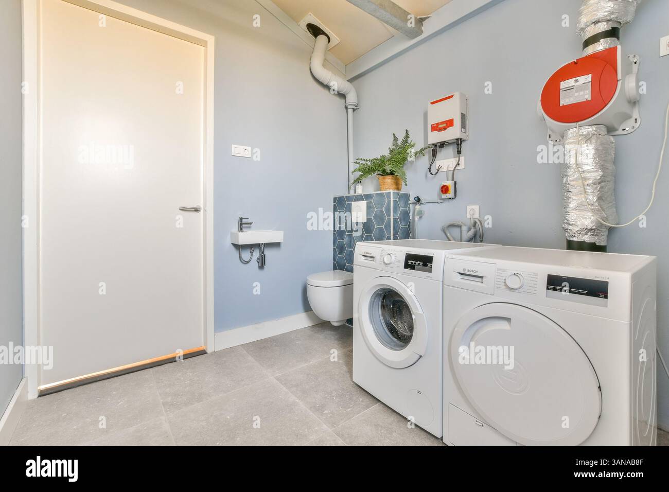 A sleek and functional laundry room featuring modern washing machine ...