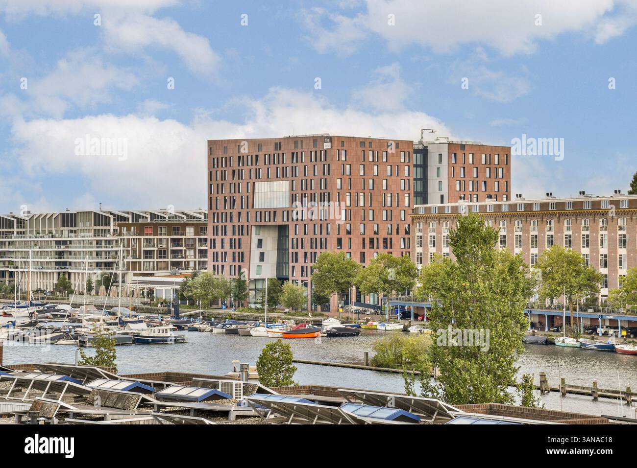 Showcasing contemporary buildings alongside a marina, this image ...