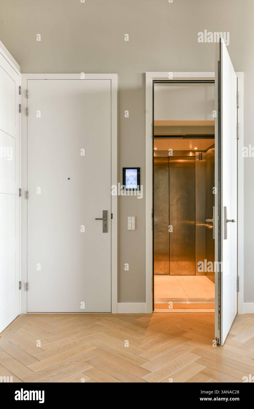 A contemporary entrance featuring a sleek door and an elevator access ...