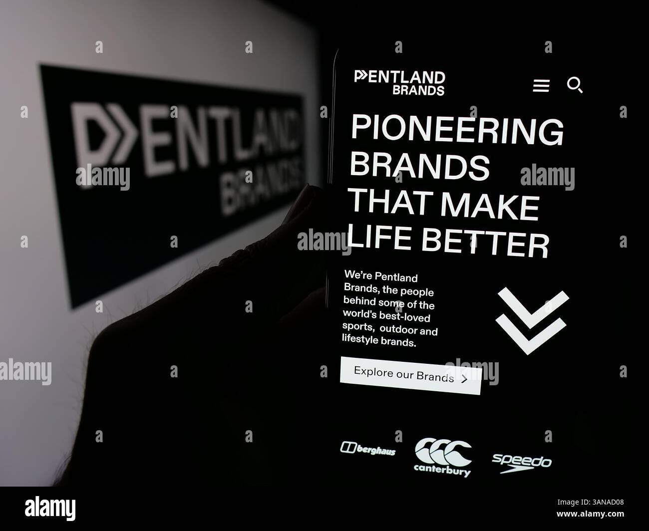 In this photo illustration, a person is holding a cellphone with the webpage of British retail ...