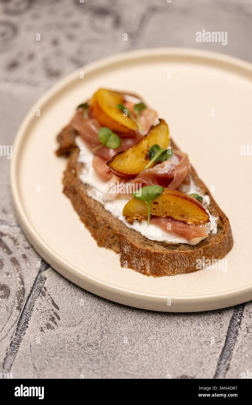 Sandwich with cream cheese, prosciutto and peach Stock Photo - Alamy