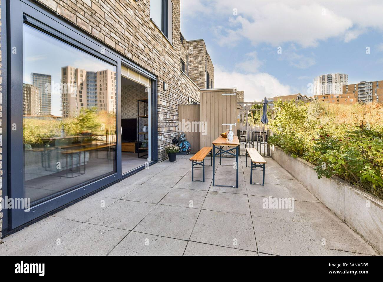 An inviting outdoor patio area featuring wooden furniture and lush ...