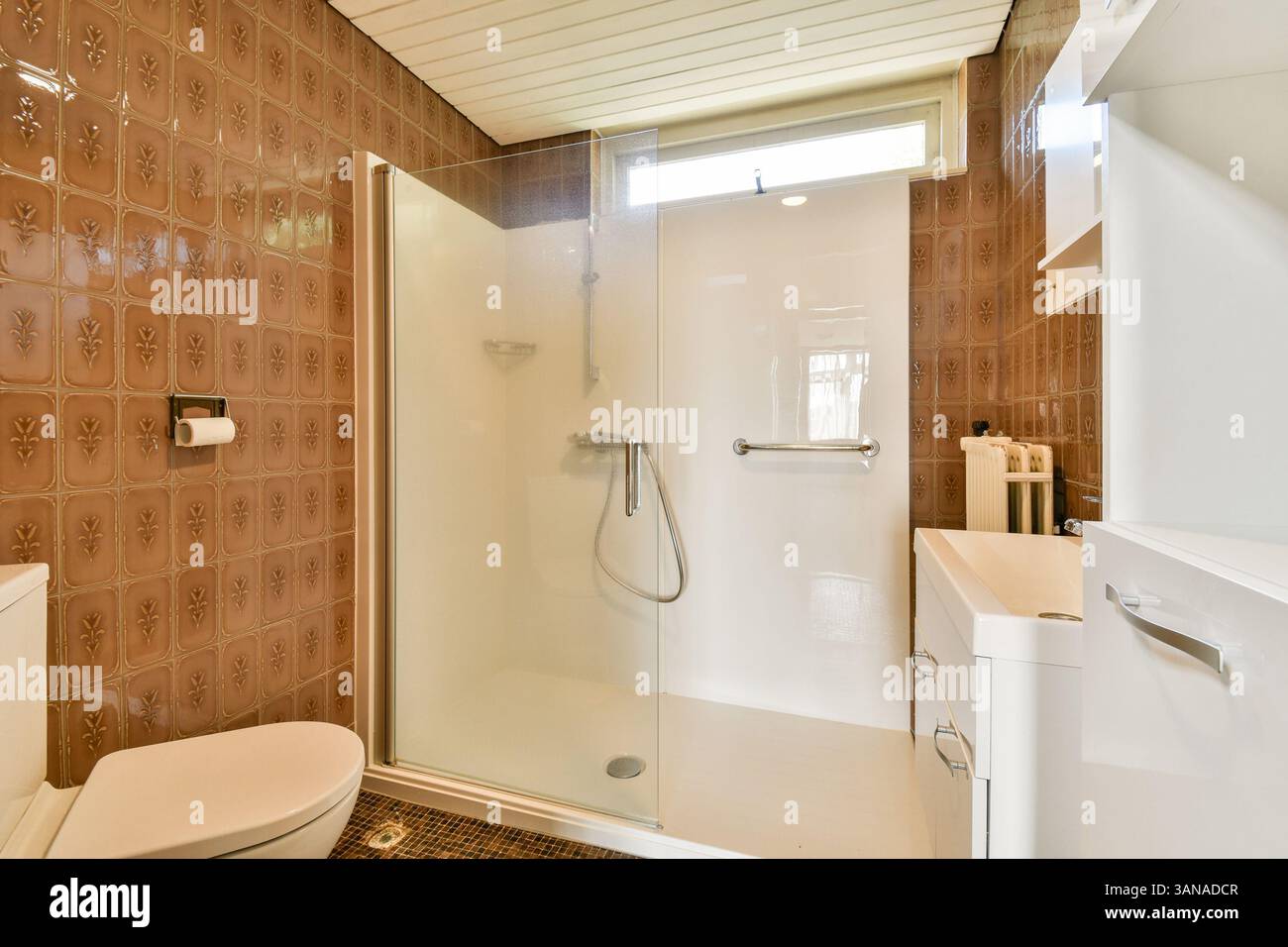 A sleek and contemporary shower room featuring a glass enclosure ...