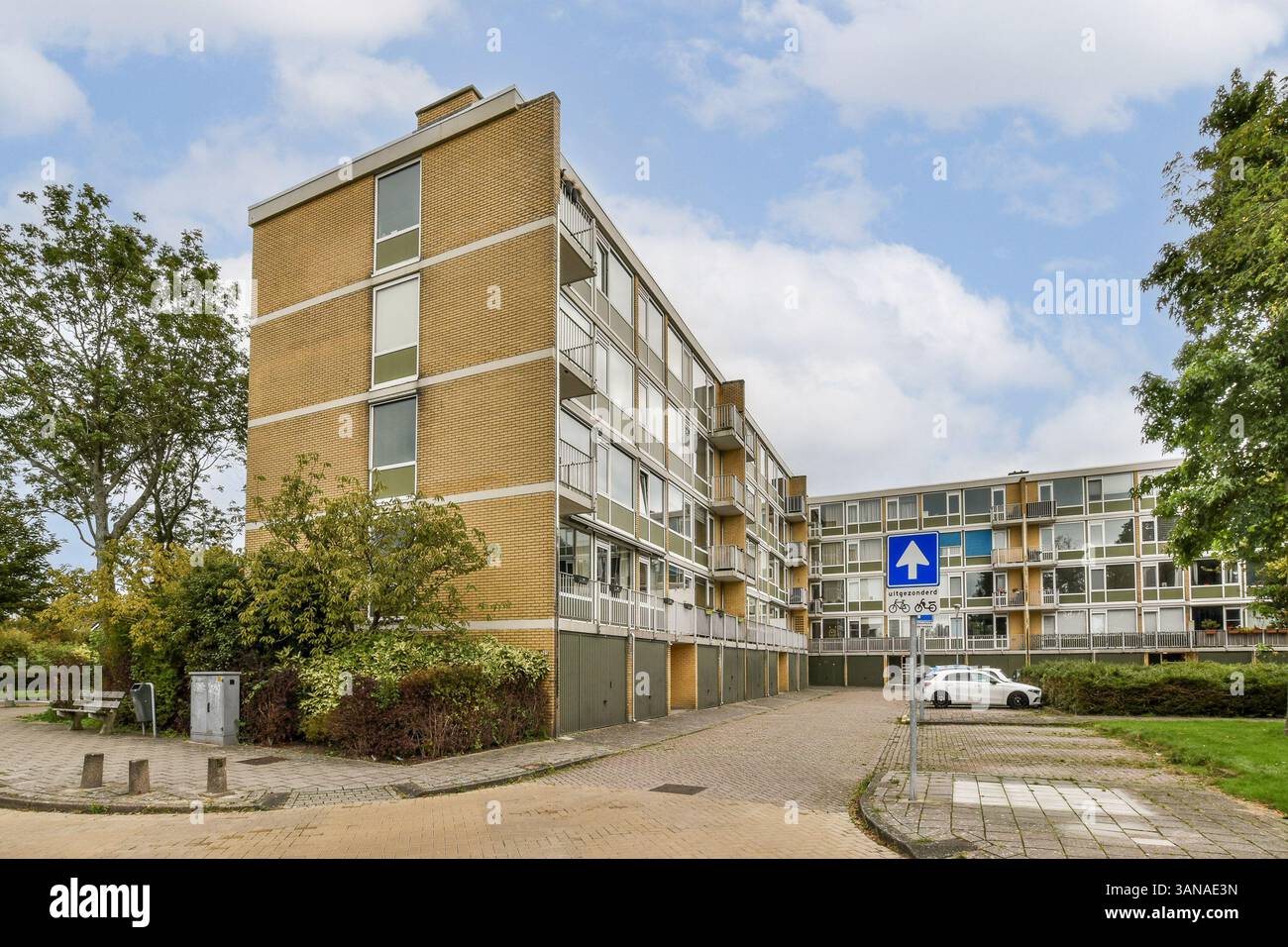 A contemporary multi-story apartment building with large windows, set ...