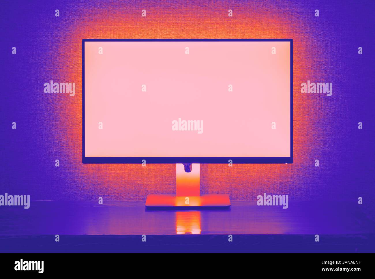 Blank monitor with backlight over gray wall in dark room in vivid neon ...