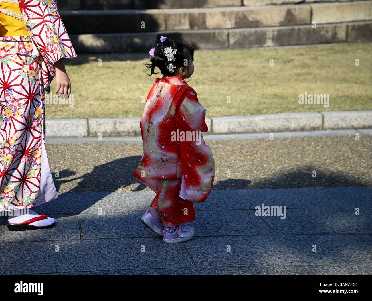 Little Japanese Geisha with her mother walking on the grounds of Yasaka ...