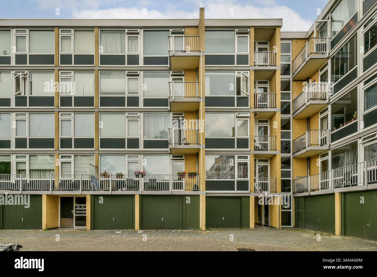 A sleek modern apartment building featuring large glass windows and ...
