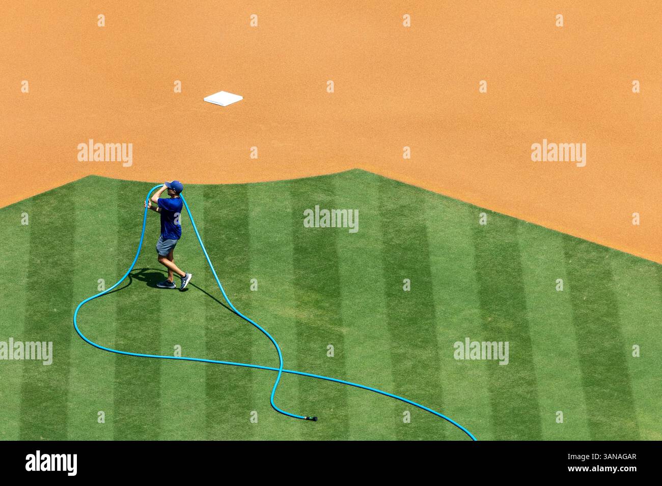 April 13, 2025: A member of the field crew preps the field at Dodger ...